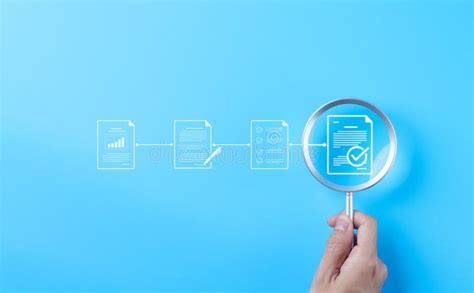 Document Review Process And Quality Control Concept Hand Holding Magnifying Glass Over A