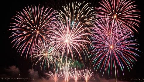 Fireworks Explode In The Night Sky Above A City Premium Ai Generated