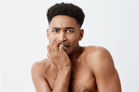 Free Photo Portrait Of Unhappy Dark Skinned African Man With Curly