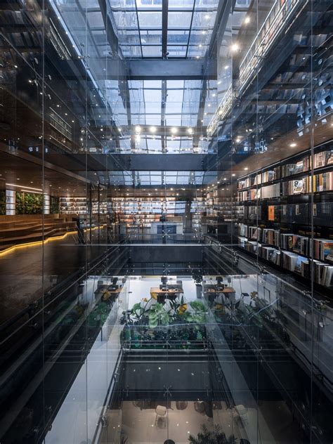 Wutopia Inserts Inverted Triangular Lightwell Into Book Shop