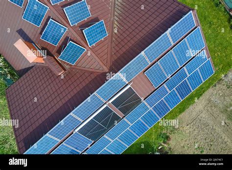 Private Home Roof Covered With Solar Photovoltaic Panels For Generating Of Clean Ecological