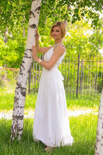 Blonde Beautiful Natural Girl With Blonde Hair In A White Dress In