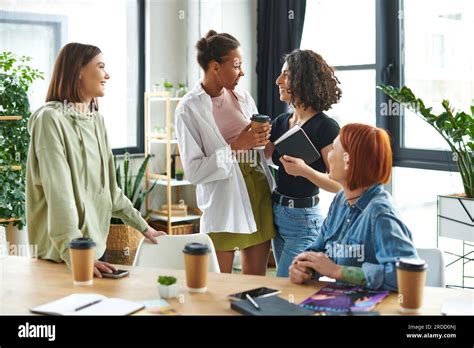 Pleased African American And Multiracial Women With Notebook And Paper
