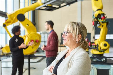 Professionals Discussing Robotics Programming And Automation In An