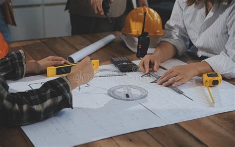 Team Of Multiethnic Architects Working On Construction Plans In Meeting Room Engineers