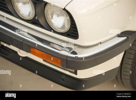 A Detailed Closeup Of A Classic Vintage Bmw E30 White Cars Front End Showcasing Chrome Detailing