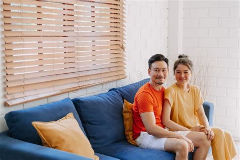 Lovely Couple Lover Sit Together On The Sofa In The Warm House Stock