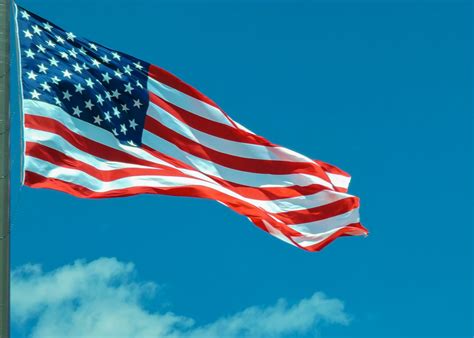 A Large American Flag Flying In The Sky Photo Free Flag Image On Unsplash