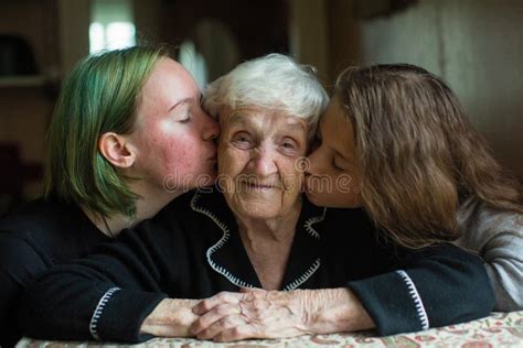 Two Girls Kiss Their Grandmother Love Black And White Portrait Stock
