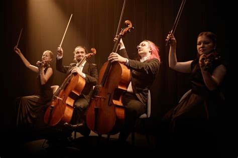Premium Photo Four Professional String Players Giving Concert On Stage