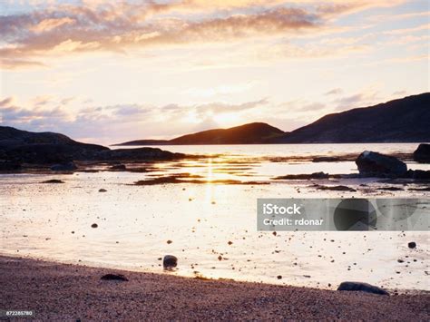 Walk Within Sunset On Beach Mirroring Of Sunsetting Horizon In Sea