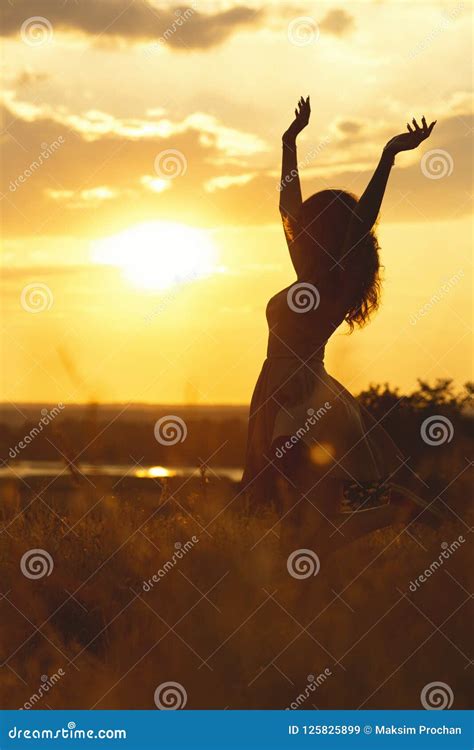 Silhouette Of A Beautiful Girl Dancind And Spinning In A Dress At