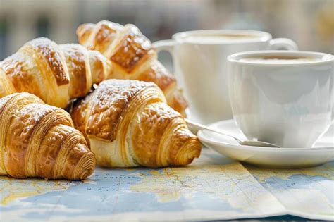 Premium Photo Croissants And A Map Planning A Journey Over Breakfast