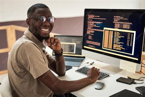 Premium Photo Portrait Of Joyful Software Developer In Glasses Programming On Computer