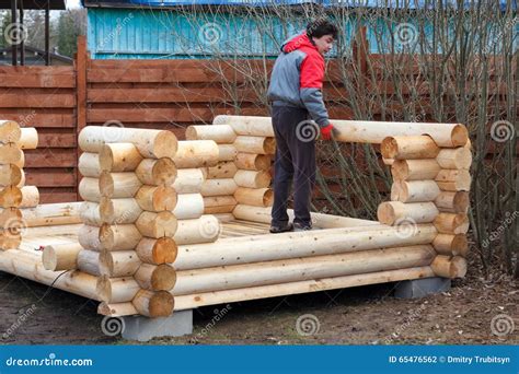 Man Builds Structure Made Of Logs Royalty Free Stock Image