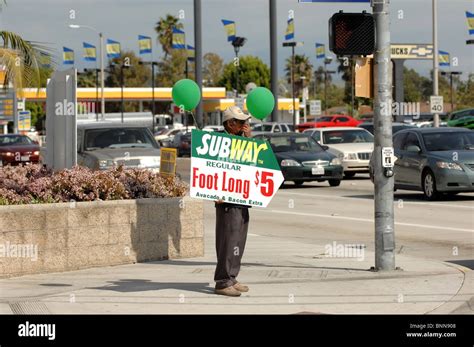Human Billboard A Man Holds An Advertising Sign On The Corner Of