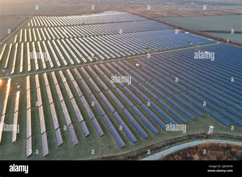 Aerial View Of Big Sustainable Electric Power Plant With Many Rows Of Solar Photovoltaic Panels