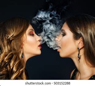 120292 Women Smoking While Putting On Makeup Royalty Free Images