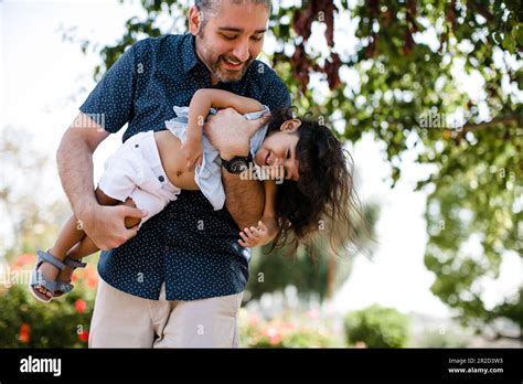 Dad Laughing Playing With Babe Under Tree Stock Photo Alamy
