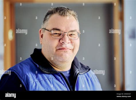 Sly Smile Of Round Faced European Man Over 40 Wearing Glasses Stock