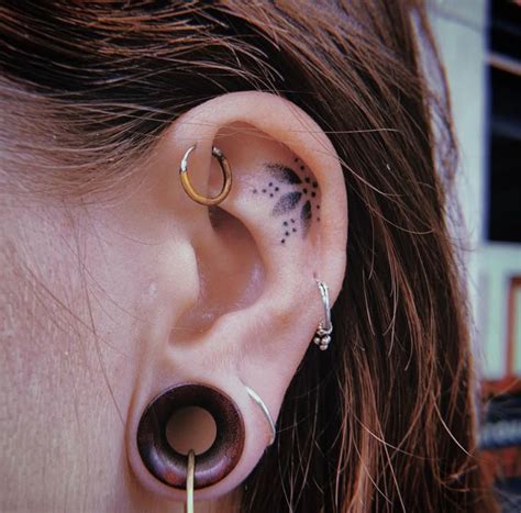 Hand Poked Tattoo On Ear Black Dot Design Ear Tattoo Lotus Hand