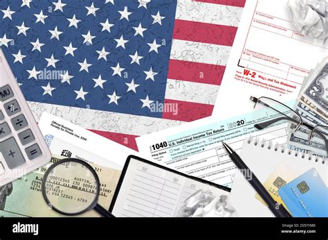 Irs Form 1040 Individual Income Tax Return And W 2 Wage And Tax Statement Lies On Office Table