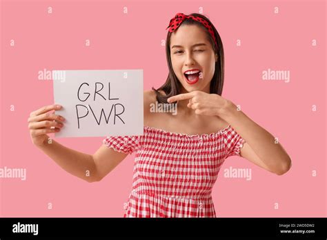 Portrait Of Young Pin Up Woman Pointing At Sign With Text Grl Pwr On