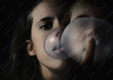 Premium Photo Double Exposure Of Woman Blowing Bubble Against Black