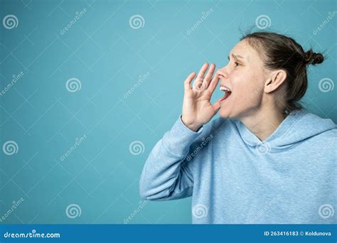Profile Of A European Alarmed Woman Who Screams Loudly Holding Her