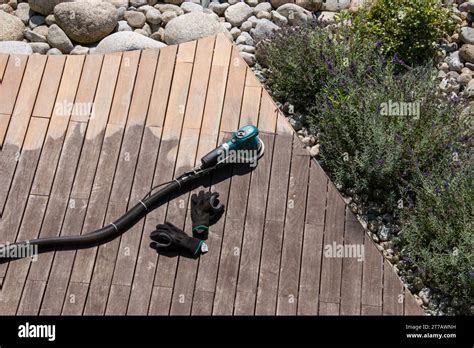 Orbital Power Sander With Antivibration Gloves On Hardwood Deck Workplace With Tools Stock