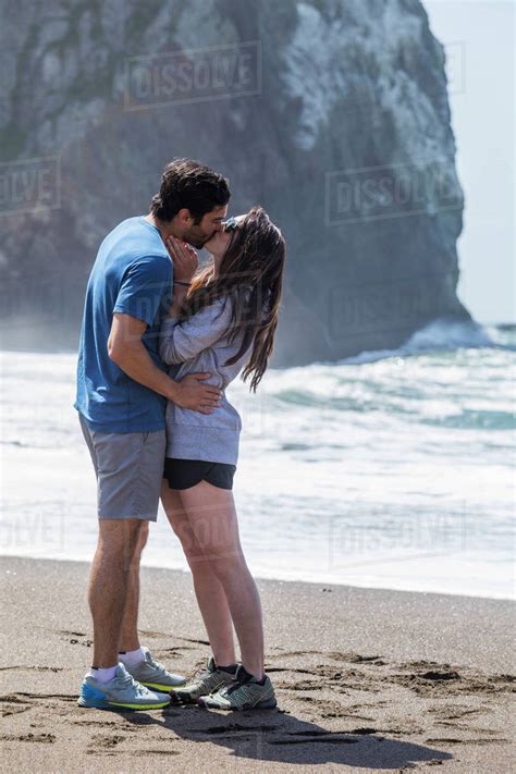 Couples Kissing On The Beach