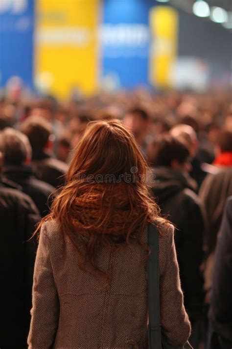 A Redhead Walks Through A Bustling Film Festival Crowd Back View Copy