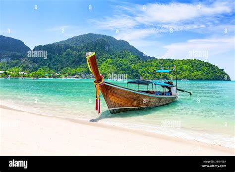 Thai Traditional Wooden Longtail Boat And Beautiful Sand Beach In Phi