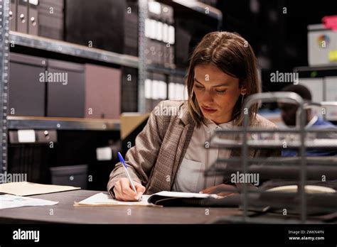 Police Officer Writing Criminology Report Working Overtime At Criminal Case Analyzing Crime