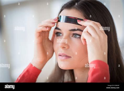 Woman Checking Her Temperature With A Strip Thermometer Stock Photo Alamy