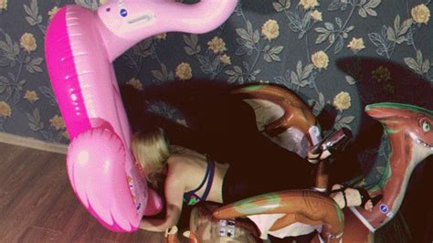 Alla Is Blowing Up A Pink Inflatable Flamingo With Her Mouth And Sitting On An Inflatable
