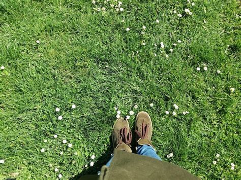 Premium Photo Low Section Of Person Standing On Grassy Field