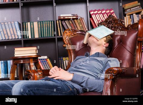Exhausted Young Man Sleeping In A Library Relaxing In A Comfortable