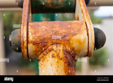 A Rusty Metal Object With A Green Handle The Object Is Old And Has A