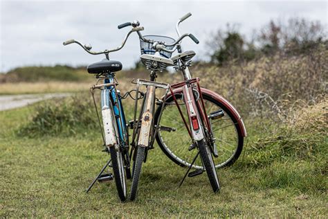 A Couple Of Bikes That Are Sitting In The Grass Photo Free Vintage