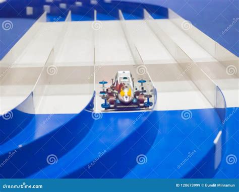 Plastic Model Scale Miniature Racing Car Running On Lane Track Stock