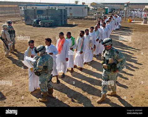 Detainees Are Checked By Us Soldiers During A Prisoner Release At Abu
