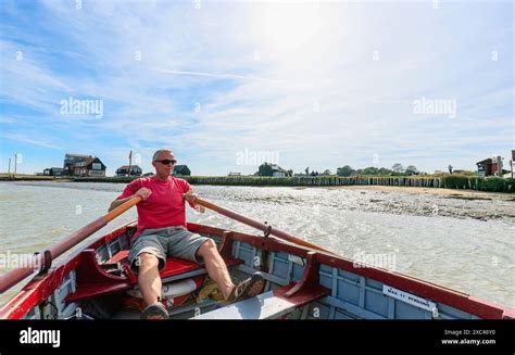 Ferryman On The Rowing Boat Ferry Crossing The River Blyth From Walberswick To Southwold In