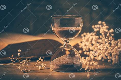 Hourglass With Old Book Symbol Of Passing Time And Memories Stock