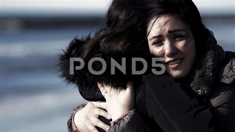 Two Sisters Hugging Sadly