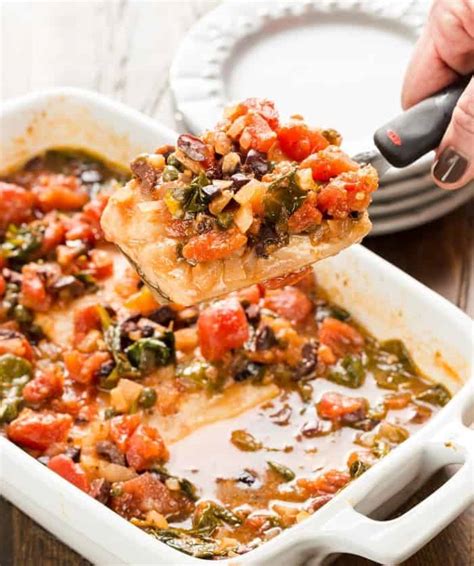 Baked Mahi Mahi With Tomatoes And Olives Garnish With Lemon