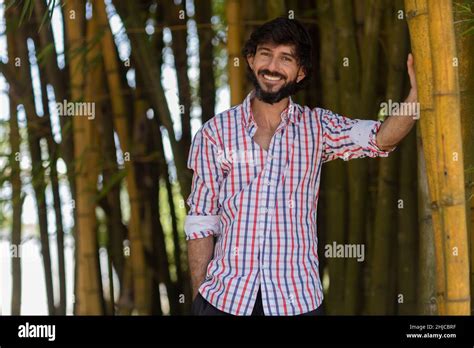 Portrait Of Smiling Young Man At A Park On A Beautiful Sunny Day Green