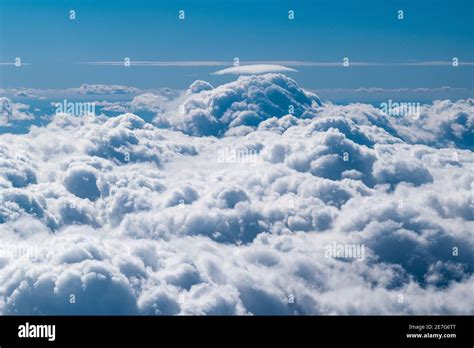 Blue Sky Full Of White Clouds In A Photo Taken In An Airplane Stock