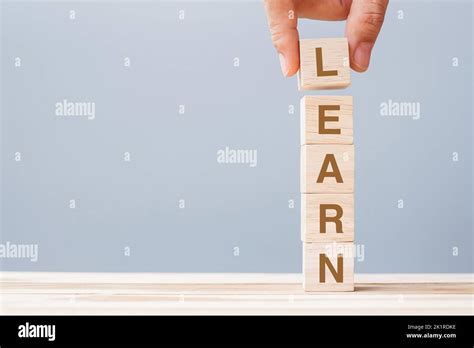 Business Man Hand Holding Wooden Cube Block With Learn Business Word On Table Background