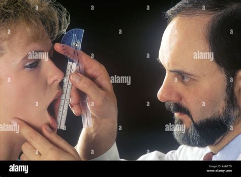 Physical Therapist Examines Patient For Tmj Temporo Mandibular Joint